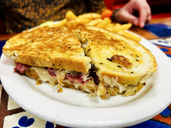 The Reuben sandwich—where corned beef, sauerkraut, and Swiss cheese perform a perfect harmony. Those golden fries are the backup singers we all need. Photo credit: Deniece W.
