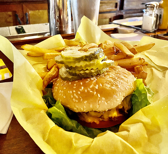 The burger basket presentation—unpretentious yet perfect. That paper wrapper isn't just packaging; it's a time-honored tradition of proper burger service.