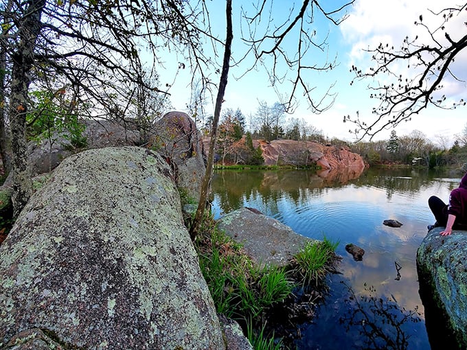 Lichen-covered granite meets crystal water at the quarry's edge, creating a natural boundary between two worlds that somehow perfectly complement each other.