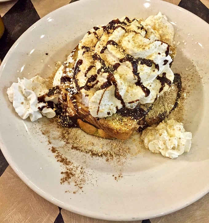 Breakfast transcends to art form with this towering creation of whipped cream, chocolate, and what appears to be French toast reincarnated as dessert.