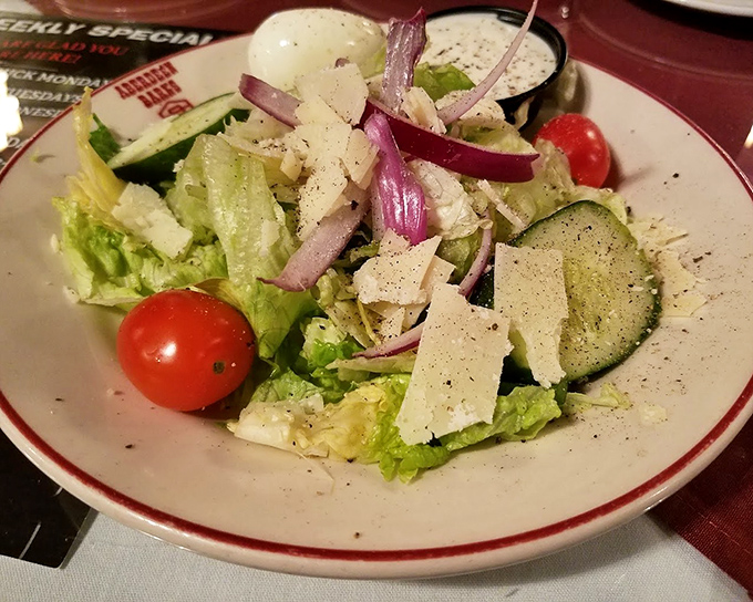 Even the salad gets the royal treatment—crisp romaine, vibrant tomatoes, and shaved parmesan that wasn't grated last Tuesday. A refreshing prelude to the meat marathon ahead.