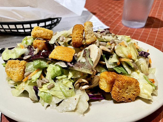 Even the salad knows its in meat country—crisp, fresh, and adorned with croutons like little flavor lifeguards ready to rescue you from vegetable boredom.