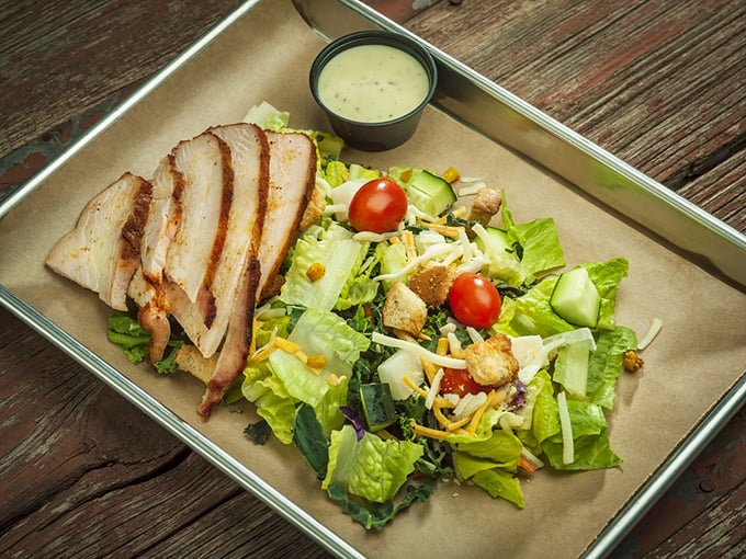 Even the salad gets the barbecue treatment. Fresh greens playing nice with smoky chicken—proof that healthy choices and flavor can coexist.