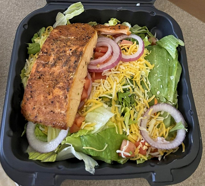 Fresh salad topped with house-smoked salmon – because even healthy choices deserve the royal treatment.