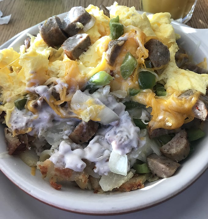 This hearty bowl of eggs, potatoes, sausage, cheese, and gravy doesn't just feed you—it hugs you from the inside. Comfort food that means business.