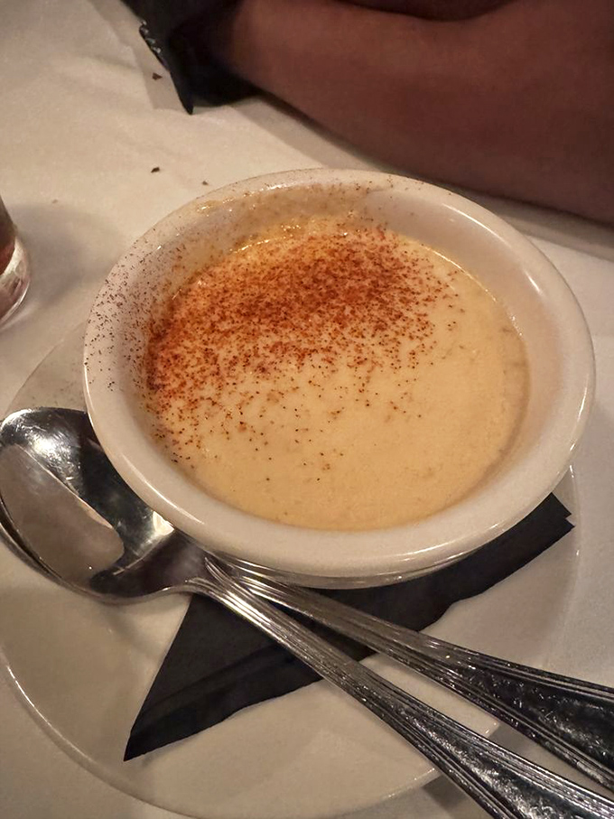 A seafood bisque so velvety it could moonlight as a spa treatment. That dusting of spice on top is like the perfect finishing touch on a masterpiece.