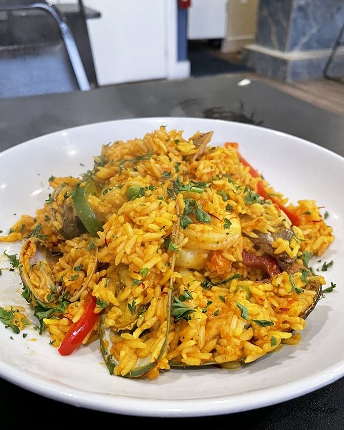 Paella that's a sunset on a plate—saffron-tinted rice cradling treasures from both land and sea in a harmonious gathering that would make United Nations diplomats jealous.