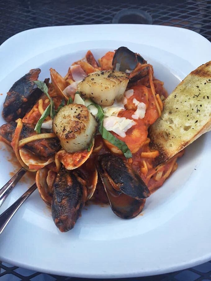 The seafood pasta that launched a thousand return trips. Those mussels aren't just hanging out—they're throwing a party with scallops in tomato sauce.