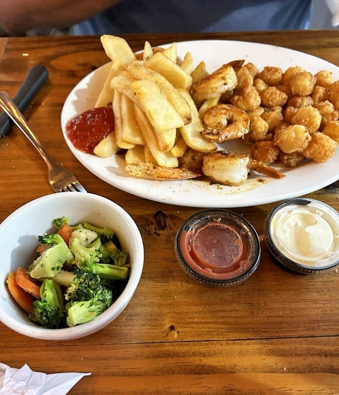 A seafood platter that hits all the right notes—crispy shrimp, golden fries, and fresh veggies. The holy trinity of coastal dining.