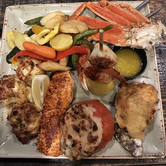 A seafood platter that's essentially Neptune's business card—crab legs, crab cakes, and fish all sharing real estate on a plate of oceanic bliss.