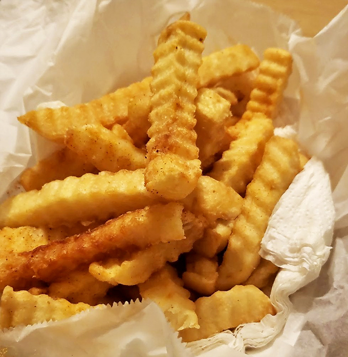 These aren't just fries—they're crispy, golden lifeboats in a sea of spice, offering momentary refuge between bites of fiery chicken.