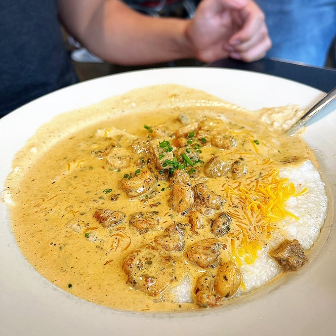 These shrimp and grits tell a Southern coastal story in every spoonful. Creamy, cheesy grits playing host to perfectly seasoned Gulf visitors.