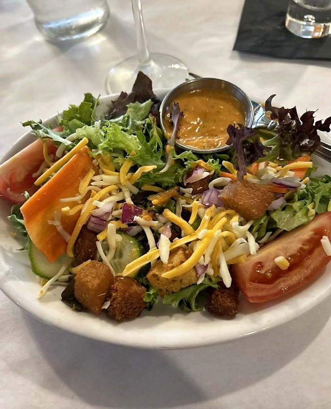 Even the salad deserves attention here—crisp, colorful, and adorned with cheese and croutons. Rabbit food that even carnivores can appreciate.