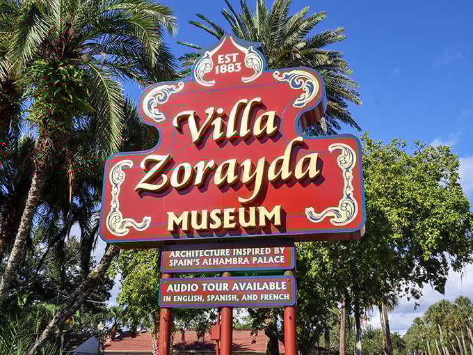 The vintage sign stands as a cheerful sentinel, palm trees swaying behind it like backup dancers for this architectural star of St. Augustine.