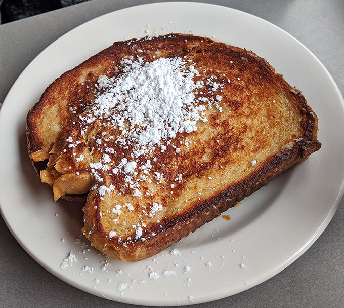 French toast that doesn't need a passport to impress—dusted with powdered sugar like the first perfect snowfall of winter.