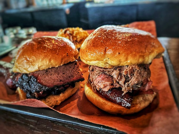 Two brisket sandwiches sitting pretty on their tray—the kind of lunch that requires a nap afterward and zero regrets.