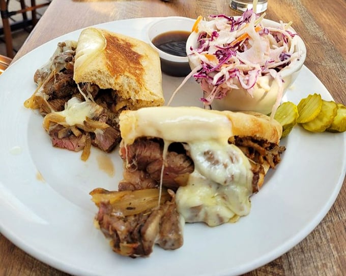 A sandwich that means business—tender prime rib, melted cheese, and caramelized onions creating the holy trinity of lunchtime perfection.