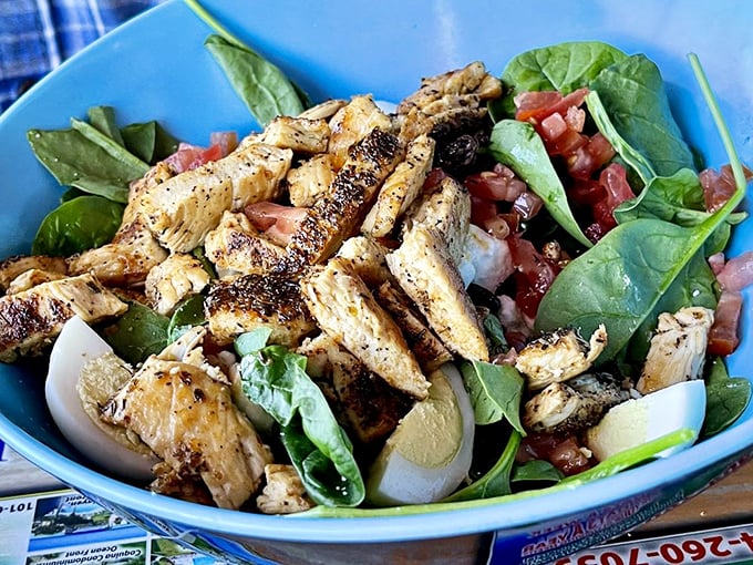 A salad that doesn't apologize for being healthy—blackened chicken and fresh spinach playing so well together you forget it's good for you.