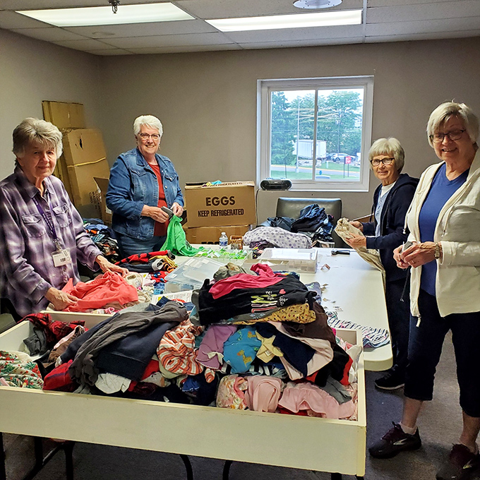 Dedicated volunteers sort through donations with the care of museum curators preserving community treasures.