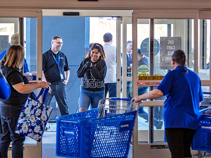 Friendly staff helping visitors navigate the treasure maze - customer service that actually makes thrift shopping enjoyable.
