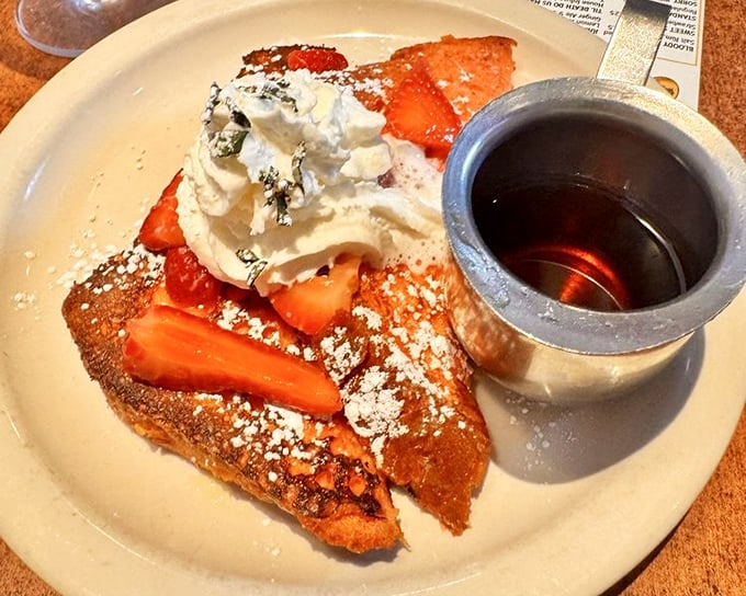 French toast that looks like it's auditioning for a dessert role but shows up for breakfast duty—strawberries never had it so good.