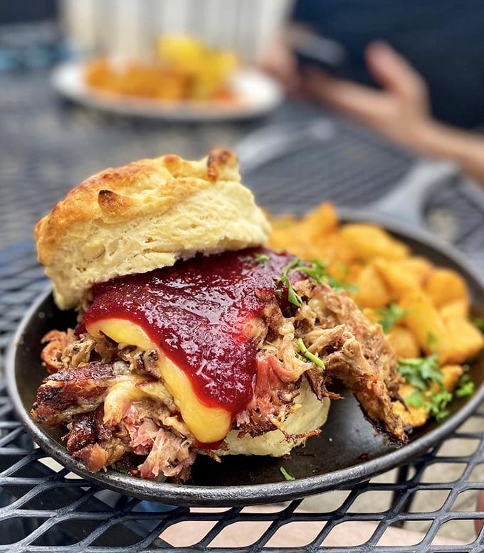 A biscuit sandwich that demands to be photographed. Slow-smoked meat meets sweet-savory jam in this handheld masterpiece of contrasting flavors.