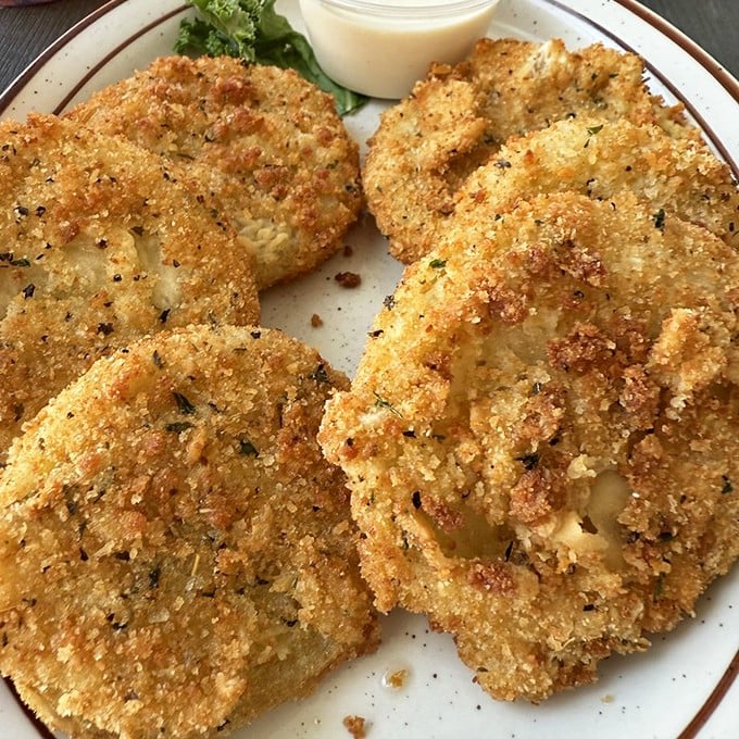 Fried green tomatoes that would make Fannie Flagg proud. These golden discs deliver that perfect sweet-tart-crispy trinity that defines Southern comfort.