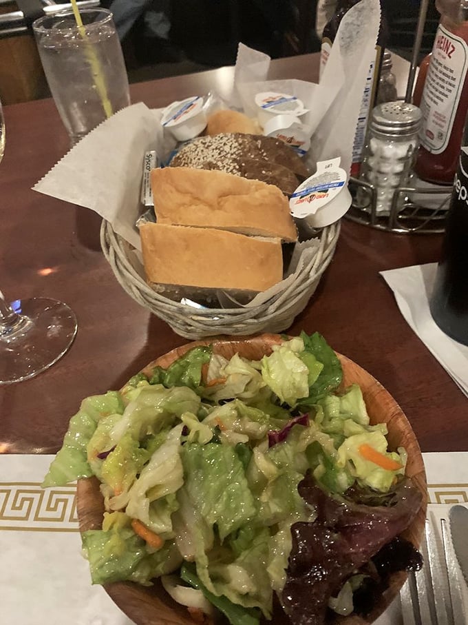 A wooden bowl of fresh salad and basket of bread—the opening act that knows its role in the barbecue symphony to follow.