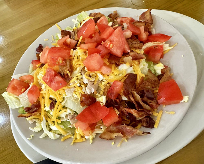 When a salad actually satisfies - crisp lettuce, sharp cheddar, bacon bits, and juicy tomatoes create a lunch that won't leave you hungry.
