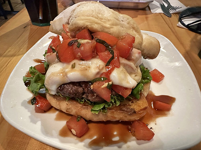 The Tuscany Burger arrives like an edible postcard from Italy—fresh tomato bruschetta and melted cheese creating a vacation between two buns.