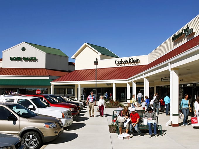 Shoppers emerge victorious from Calvin Klein, bags in hand—the universal expression of "Wait till you see what I got for half-price!"