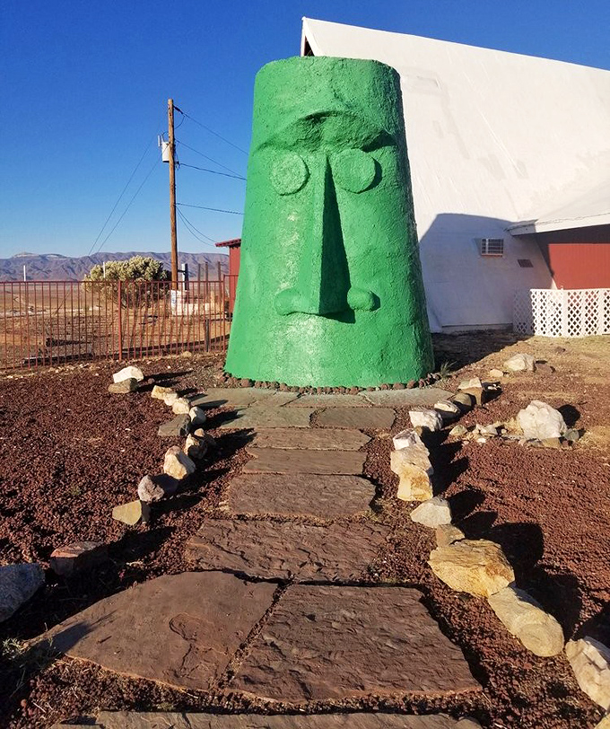 The ceremonial approach to the green sentinel feels like you're about to meet an oracle—one that dispenses wisdom about the perfect road trip snacks.