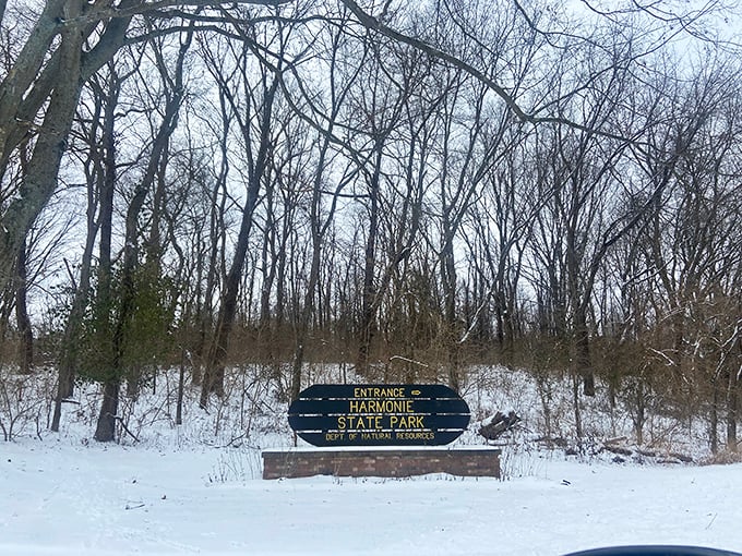 Winter transforms Harmonie into a snow-dusted wonderland. The park entrance sign stands as a promise of quiet solitude.