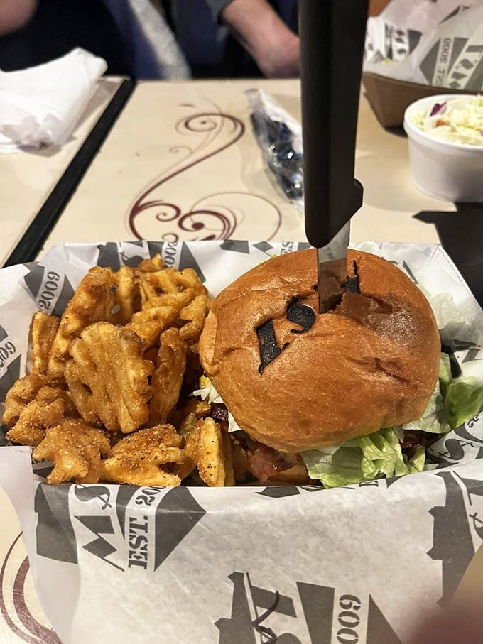 This isn't just a burger—it's an architectural marvel of toppings that somehow maintains structural integrity while delivering maximum flavor payload.