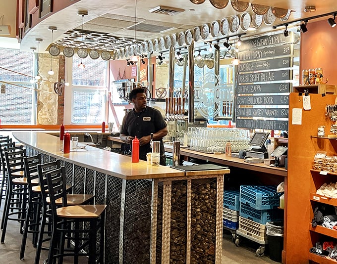 The bar area showcases the brewing equipment behind glass, where beer science happens before your very eyes—like Willy Wonka's factory, but for grown-ups.