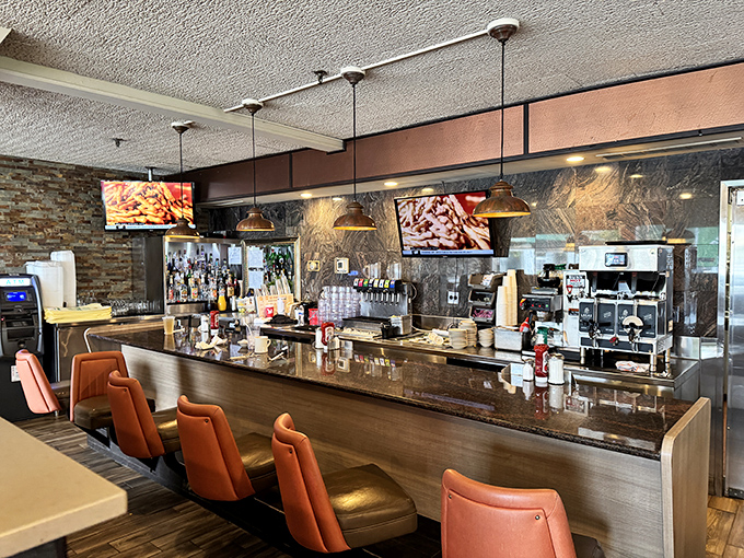 The bar area balances modern touches with classic diner appeal—where morning coffee and evening cocktails find equal respect under pendant lighting.