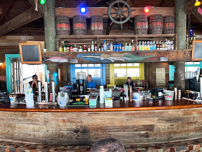 The bar at Pompano Joe's looks like it was built by sailors with excellent taste. Weathered wood, colorful rum barrels, and ocean views make every drink taste better.