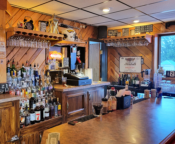 The wood-paneled bar area, where Wisconsin sports memorabilia meets perfectly arranged bottles. Liquid happiness dispensed with a smile.