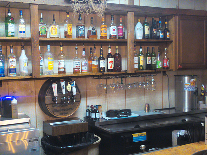 The bar area – where bottles stand at attention, ready to complement whatever treasure from the sea lands on your plate.