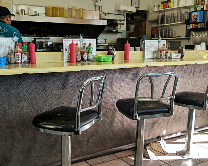 The counter seats—where regulars become family and first-timers become regulars. Watch culinary magic happen while perched on these chrome thrones.