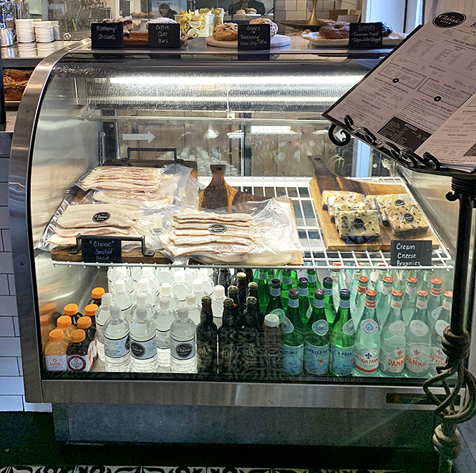 The display case—where beverages stand at attention and pastries pose prettily, silently campaigning for your attention and appetite.