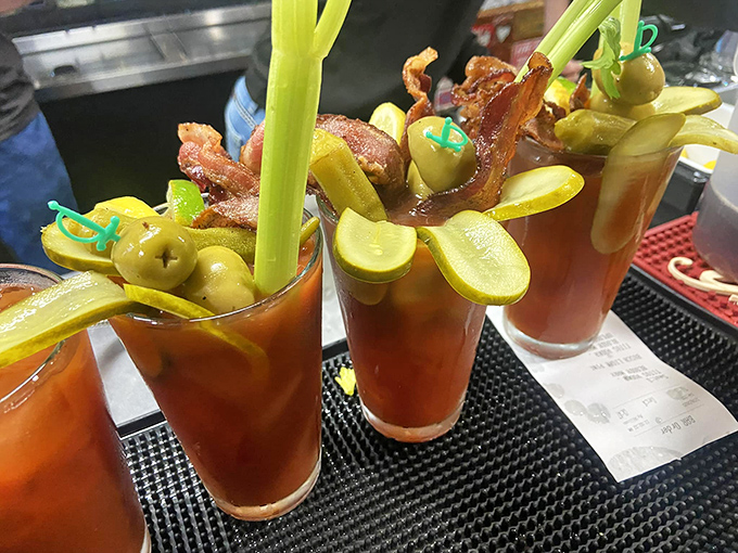 The Bloody Mary lineup that puts ordinary brunches to shame. Each glass is practically a meal, with those pickle spears standing at attention.