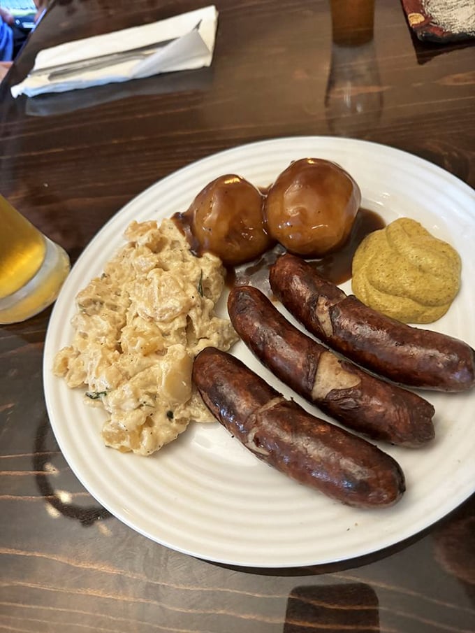These bratwursts aren't just sausages; they're ambassadors of flavor, served with German potato salad and mustard that means business.