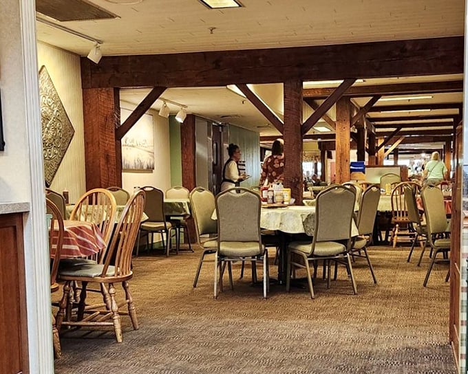 Exposed wooden beams frame dining spaces that feel both spacious and intimate—like eating in your dream country home's dining room.