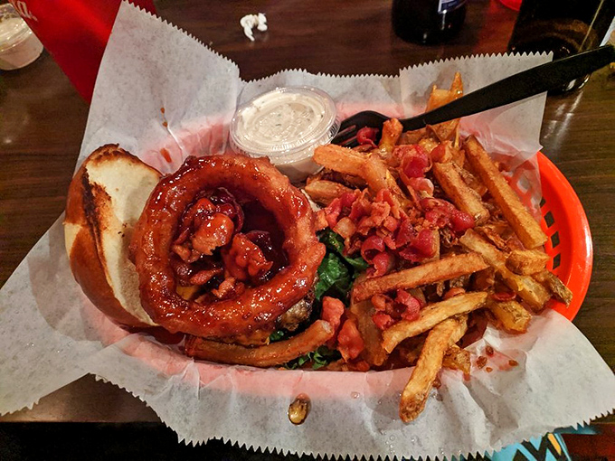 The glossy pretzel bun cradles a perfectly cooked patty and fresh greens – proof that beauty in food requires no filter.