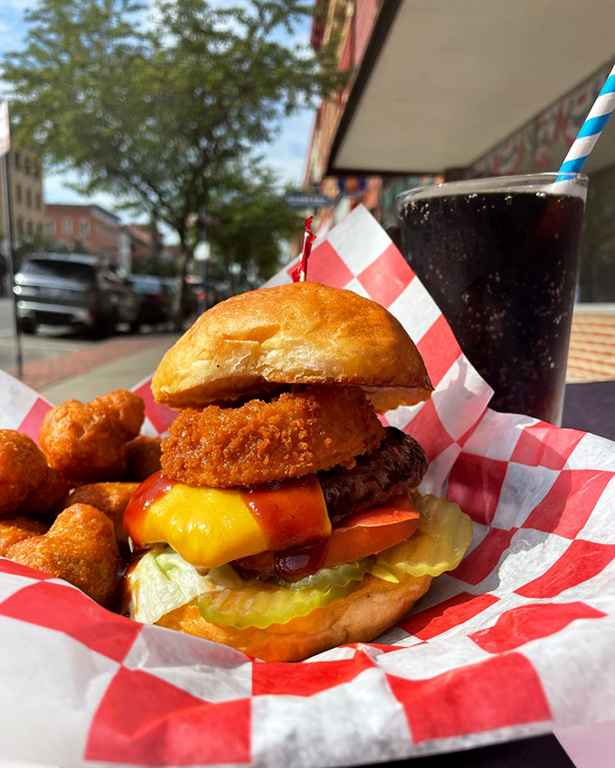 A burger that demands to be eaten with both hands and a stack of napkins—the universal sign of something worth the mess.