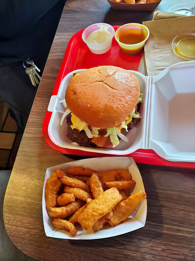 A proper burger with all the fixings, nestled in its foam throne. No pretentious stacking or architectural feats—just honest-to-goodness flavor.