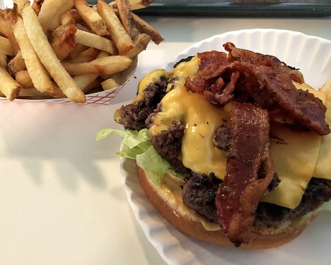 This isn't just a bacon cheeseburger—it's proof that sometimes the simplest pleasures in life are stacked three inches high and require both hands.