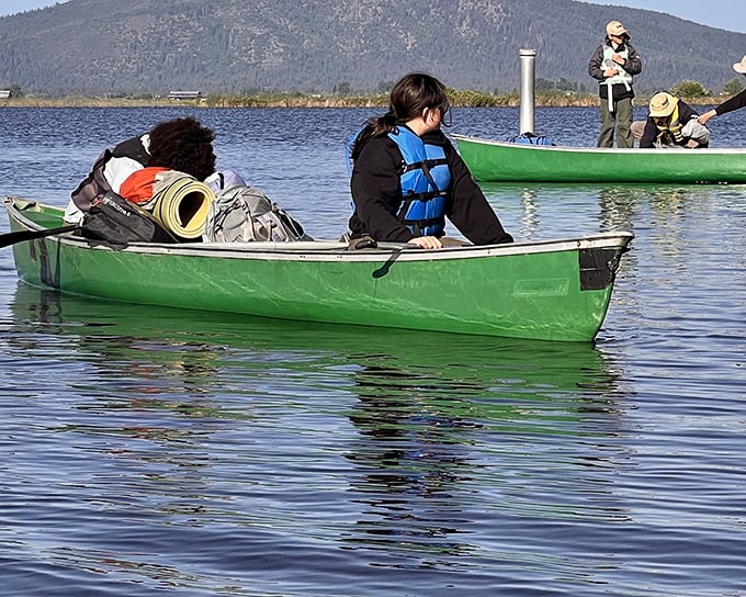 Green canoes loaded with adventure essentials—proof that the best journeys often start with simple vessels and hopeful hearts.