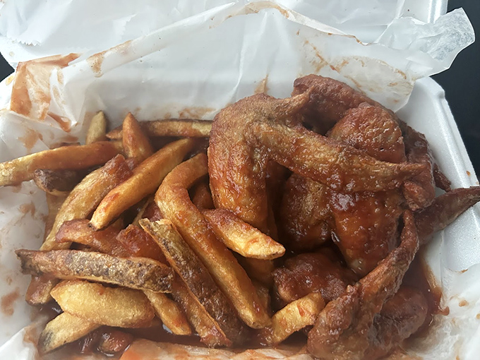 The perfect marriage: wings and fries sharing a container like old friends catching up. This isn't just takeout—it's therapy in a styrofoam box.